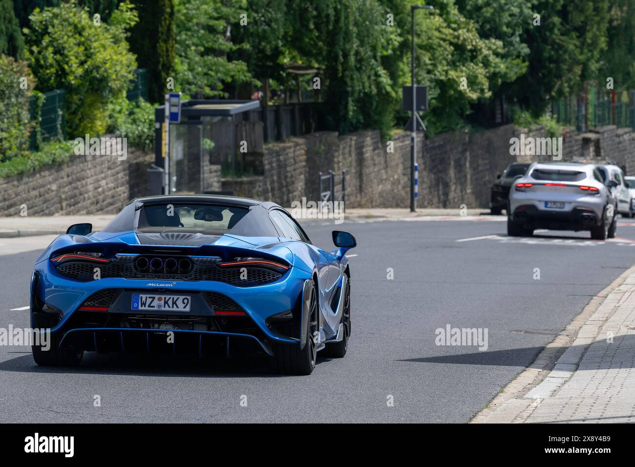 Remich, Luxembourg - View on a blue McLaren 765LT Spider driving on a ...