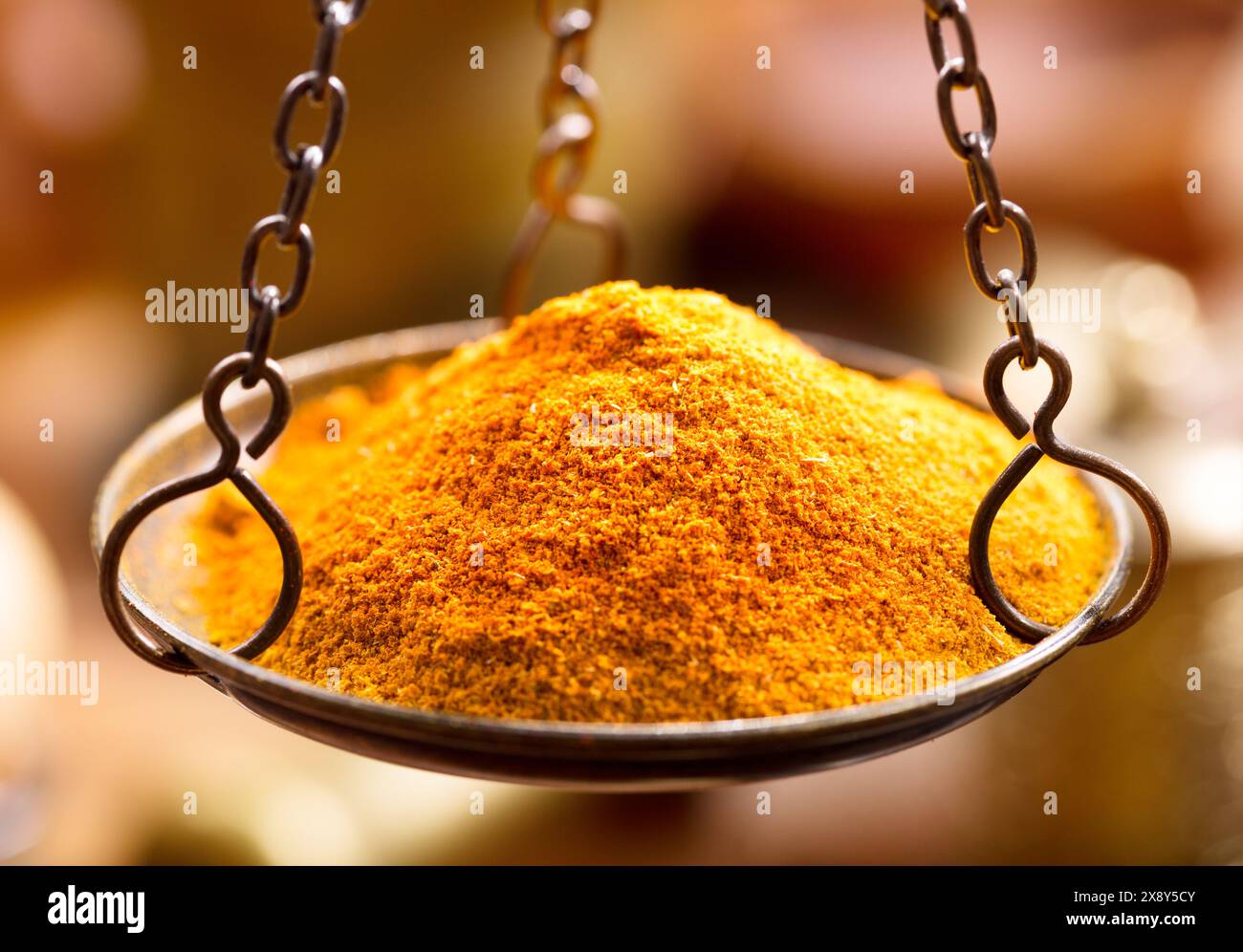 curry spice powder in vintage iron balance scale Stock Photo - Alamy