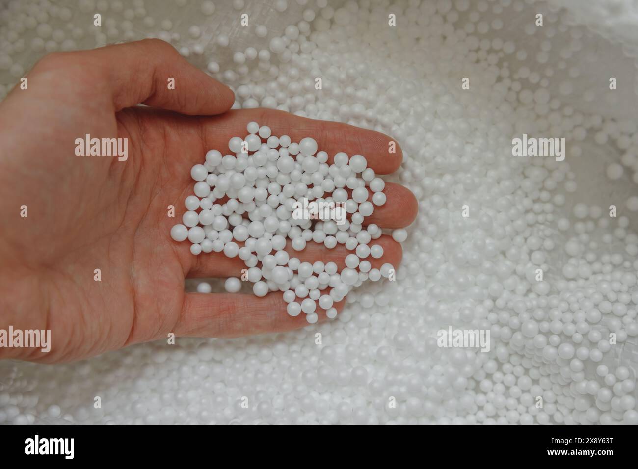 Polystyrene balls in hand. Packaging of fragile goods, filling for ...