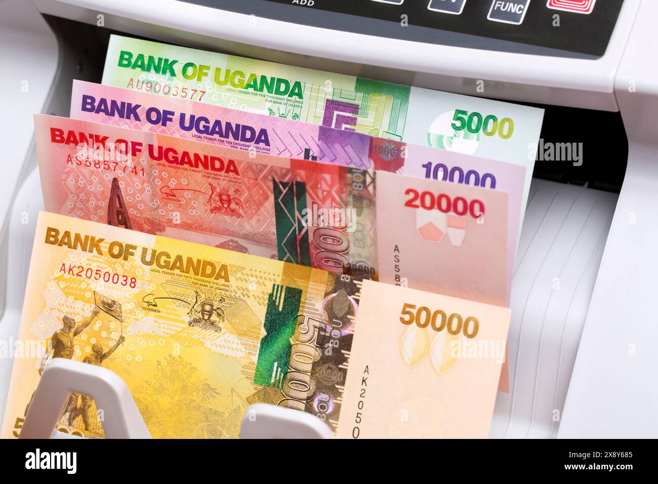 Ugandan money - shilling in a counting machine Stock Photo - Alamy