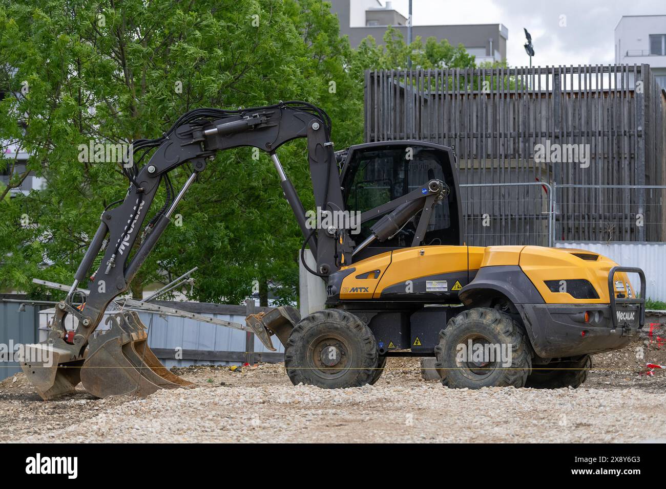 Nancy, France - Yellow and dark grey wheeled excavator Mecalac 12MTX on ...