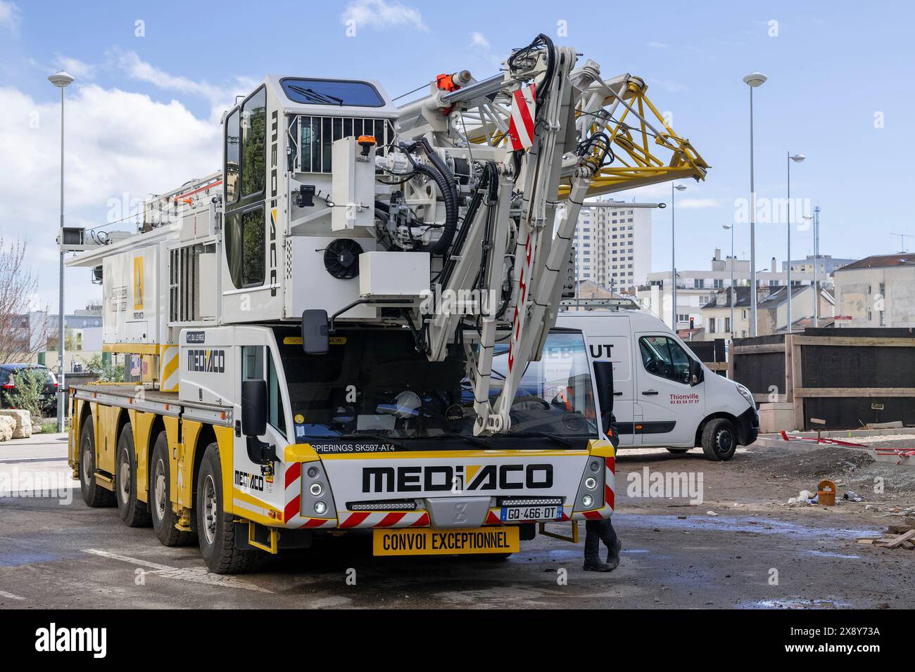 Nancy, France - White and yellow mobile construction crane Spierings SK597-AT4 eLift parked on a ...