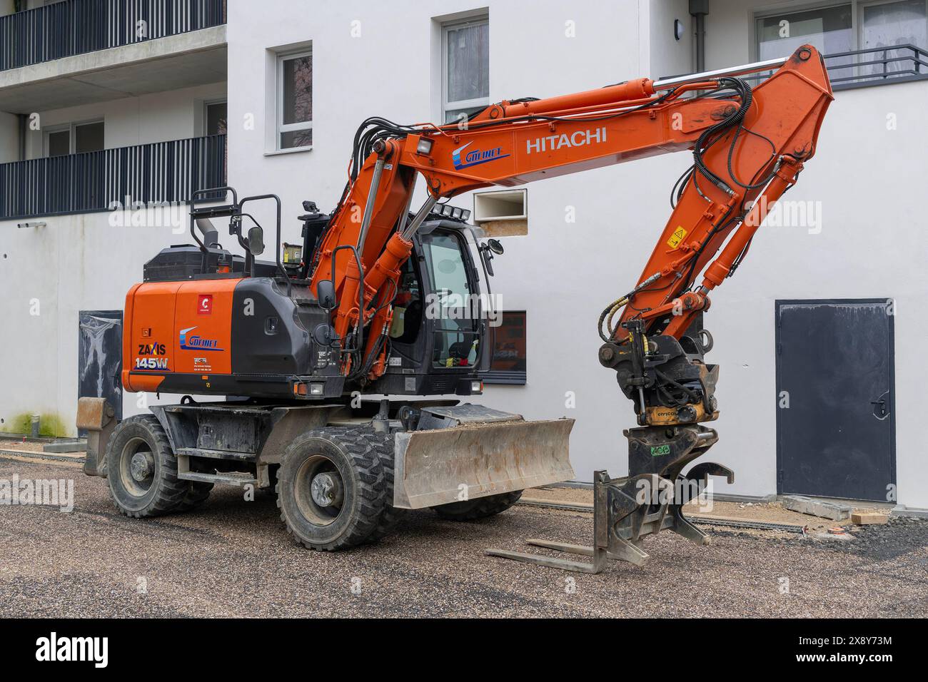 Nancy, France - Focus on an orange wheeled excavator Hitachi ZX145W-6 ...