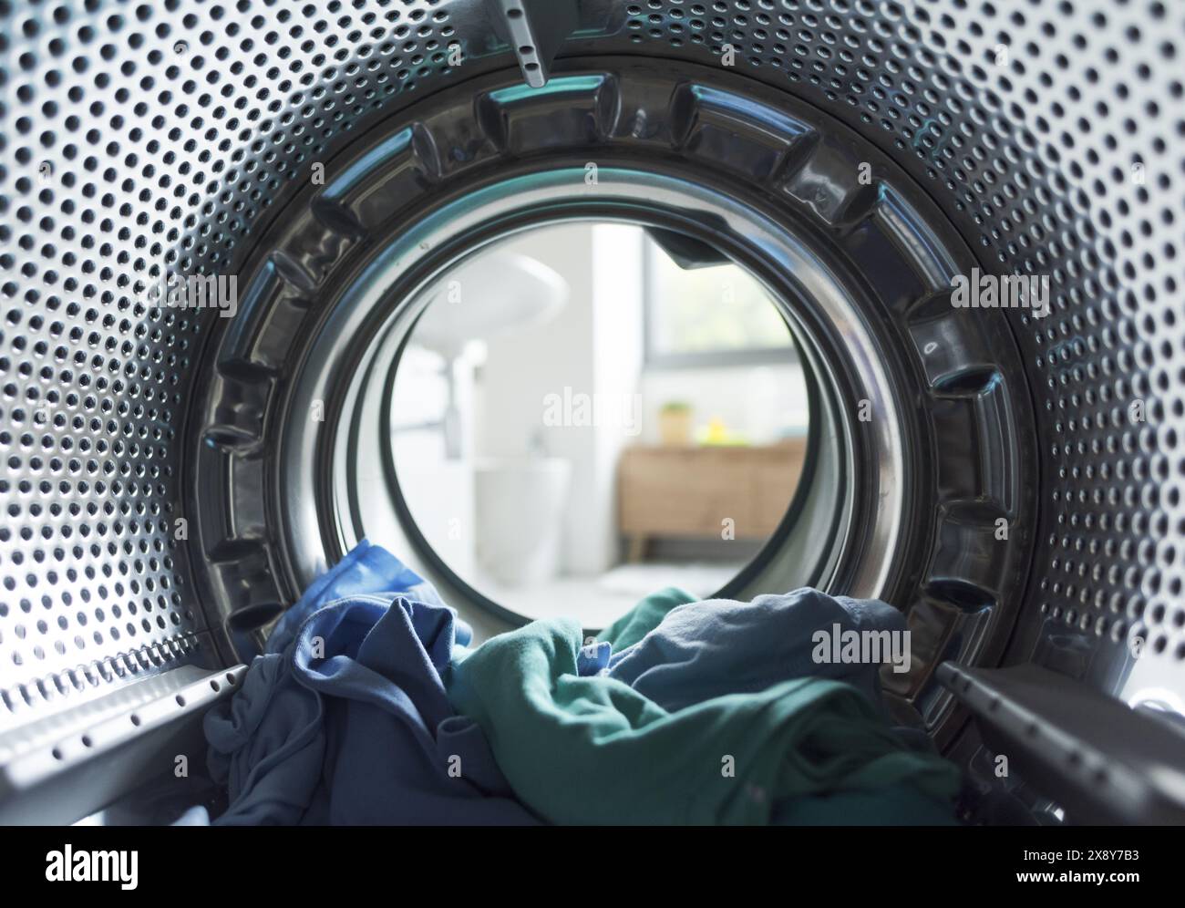 Clothes inside the washing machine, laundry and hygiene concept Stock ...