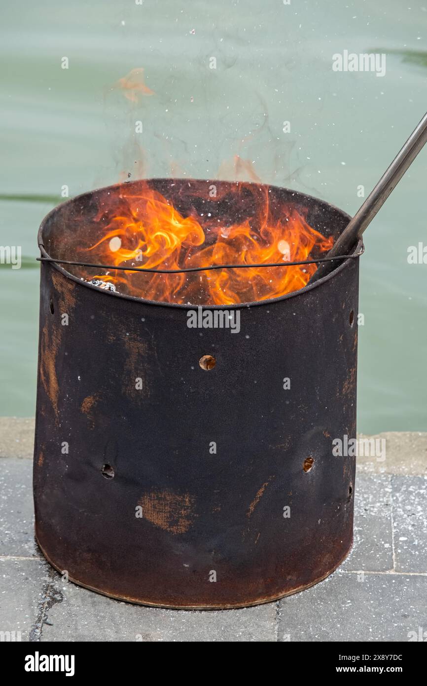 Firewood is burning in an iron barrel. Fire close-up. Burning garden ...