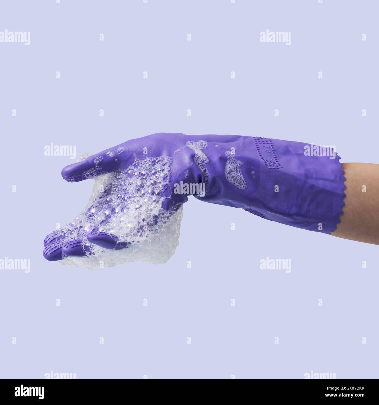 Female hand wearing a cleaning glove and showing foaming soap, hygiene ...