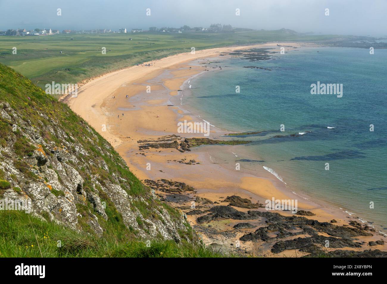 Looking down to a sandy beach from the Fife Coastal path which goes ...