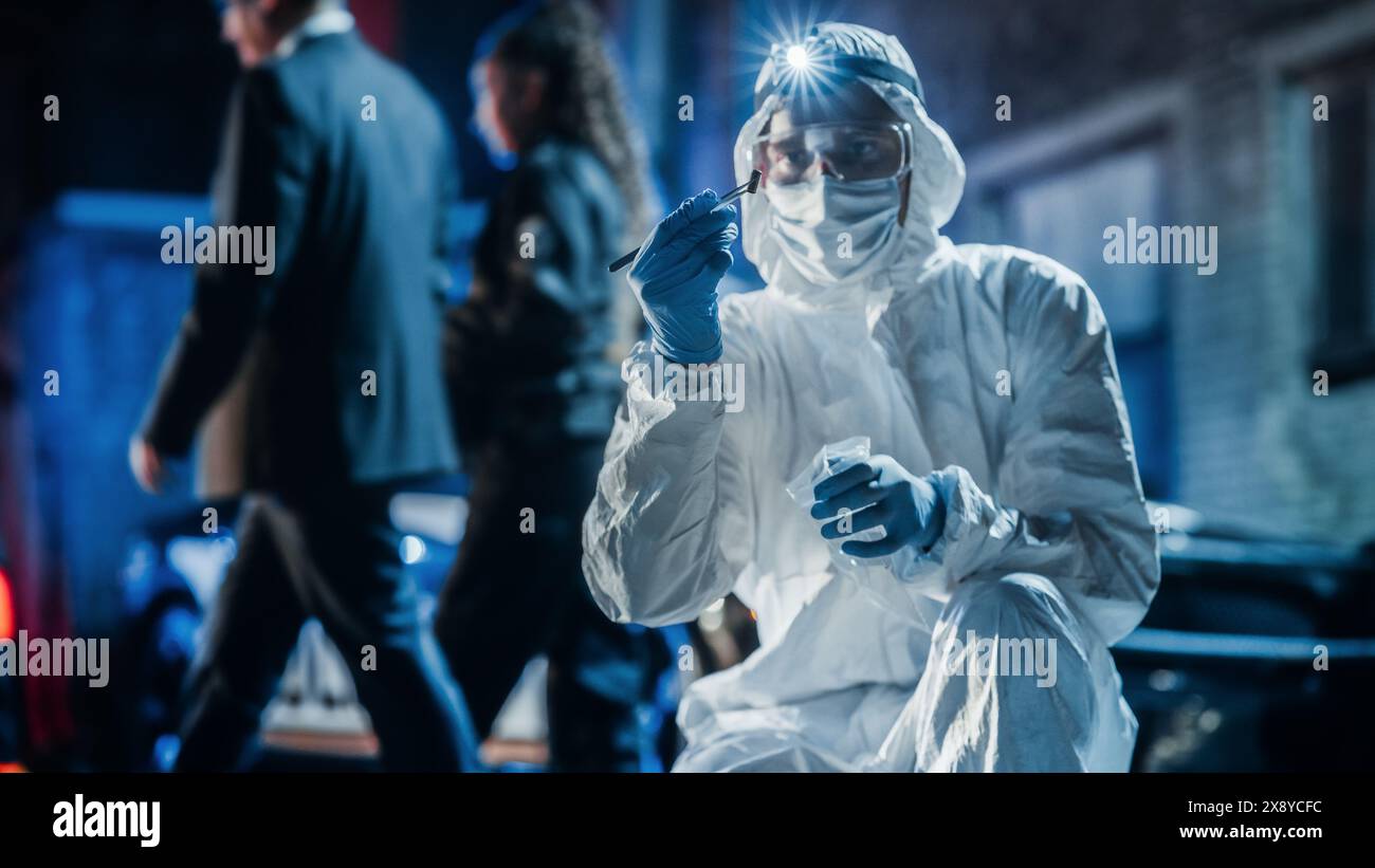 Forensics Technician in Coveralls Inspecting Potential Incriminating ...