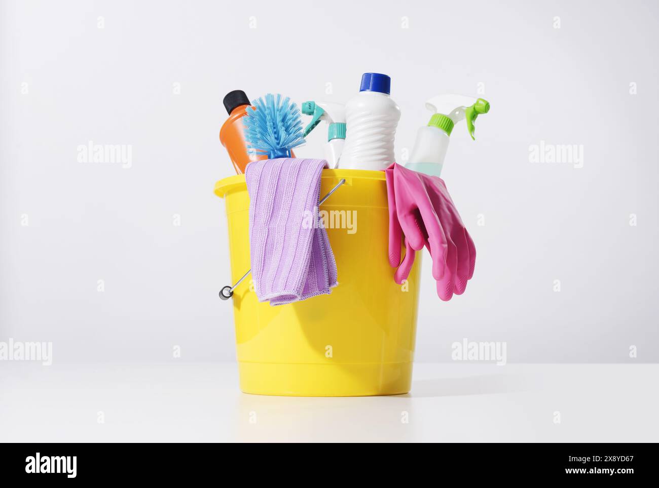 Assorted cleaning supplies in a plastic bucket, hygiene and ...