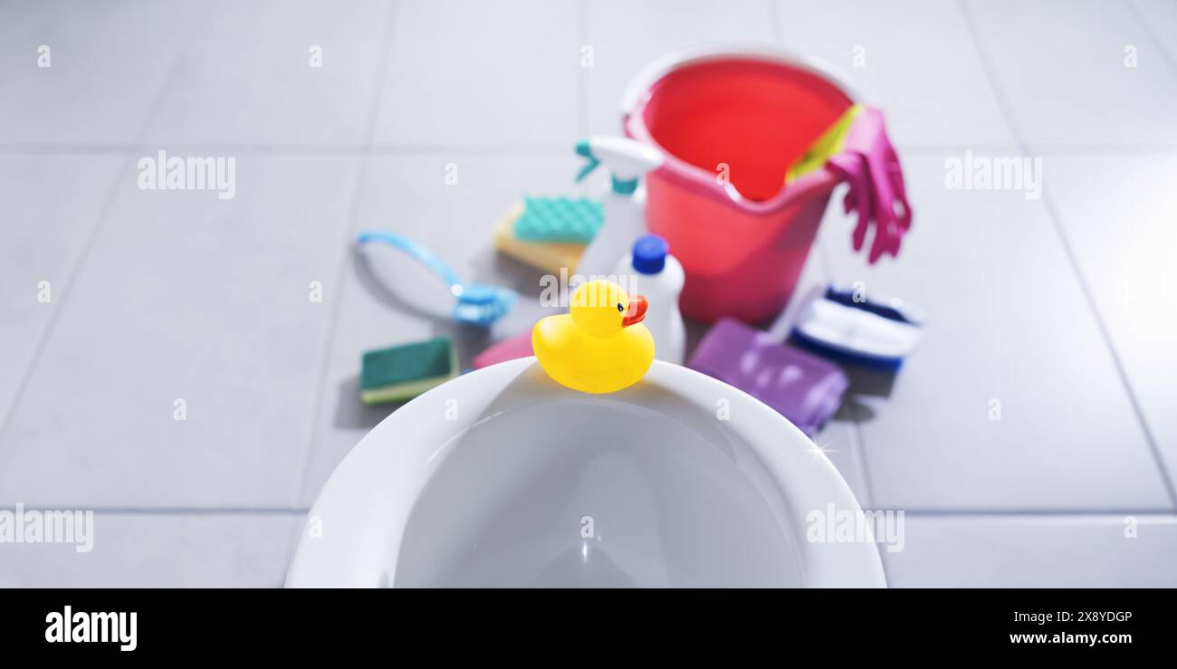 Rubber duck on a clean shiny toilet, cleaning products on the floor ...