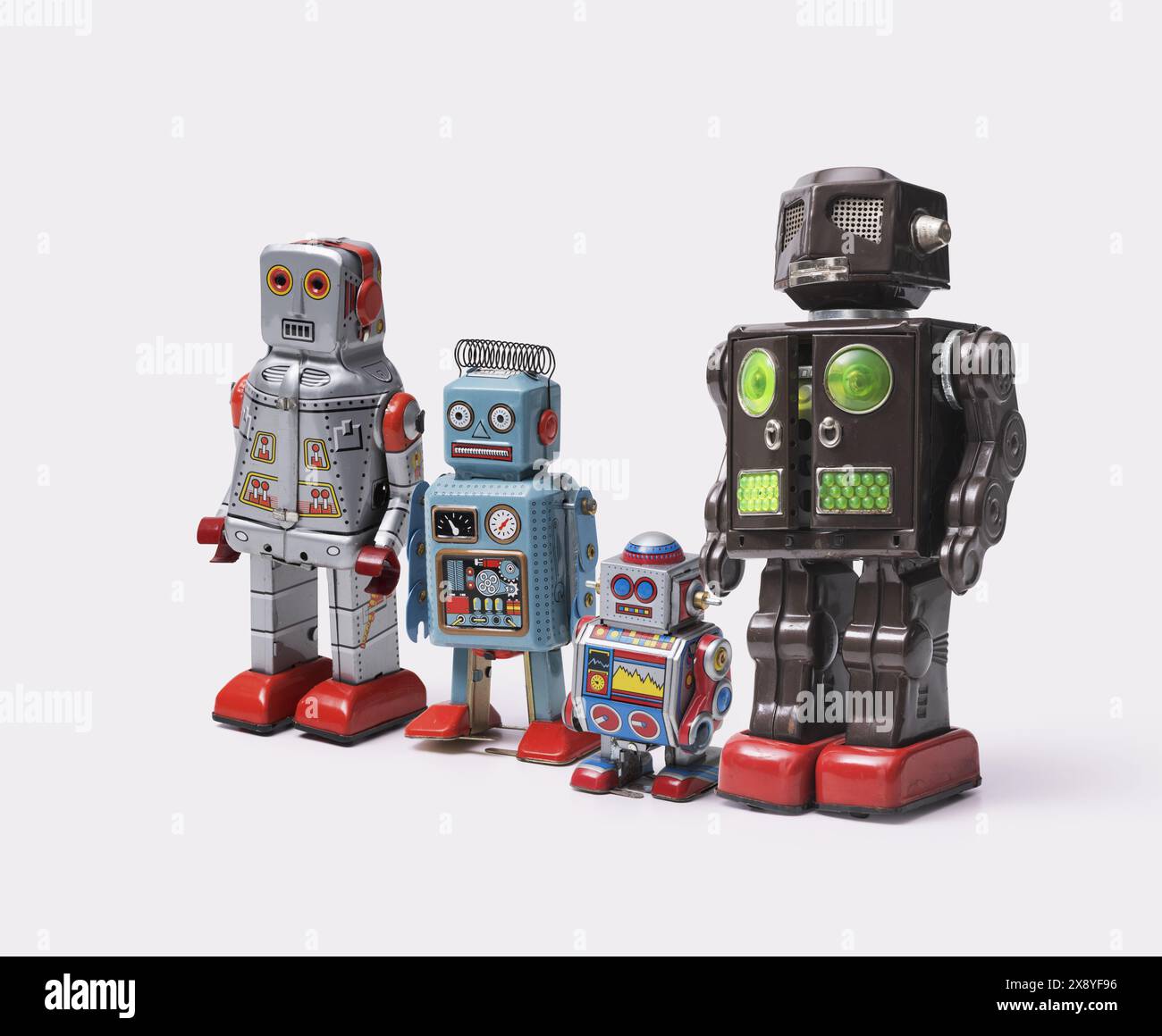 Funny cute tin toy robots standing together on white background Stock ...