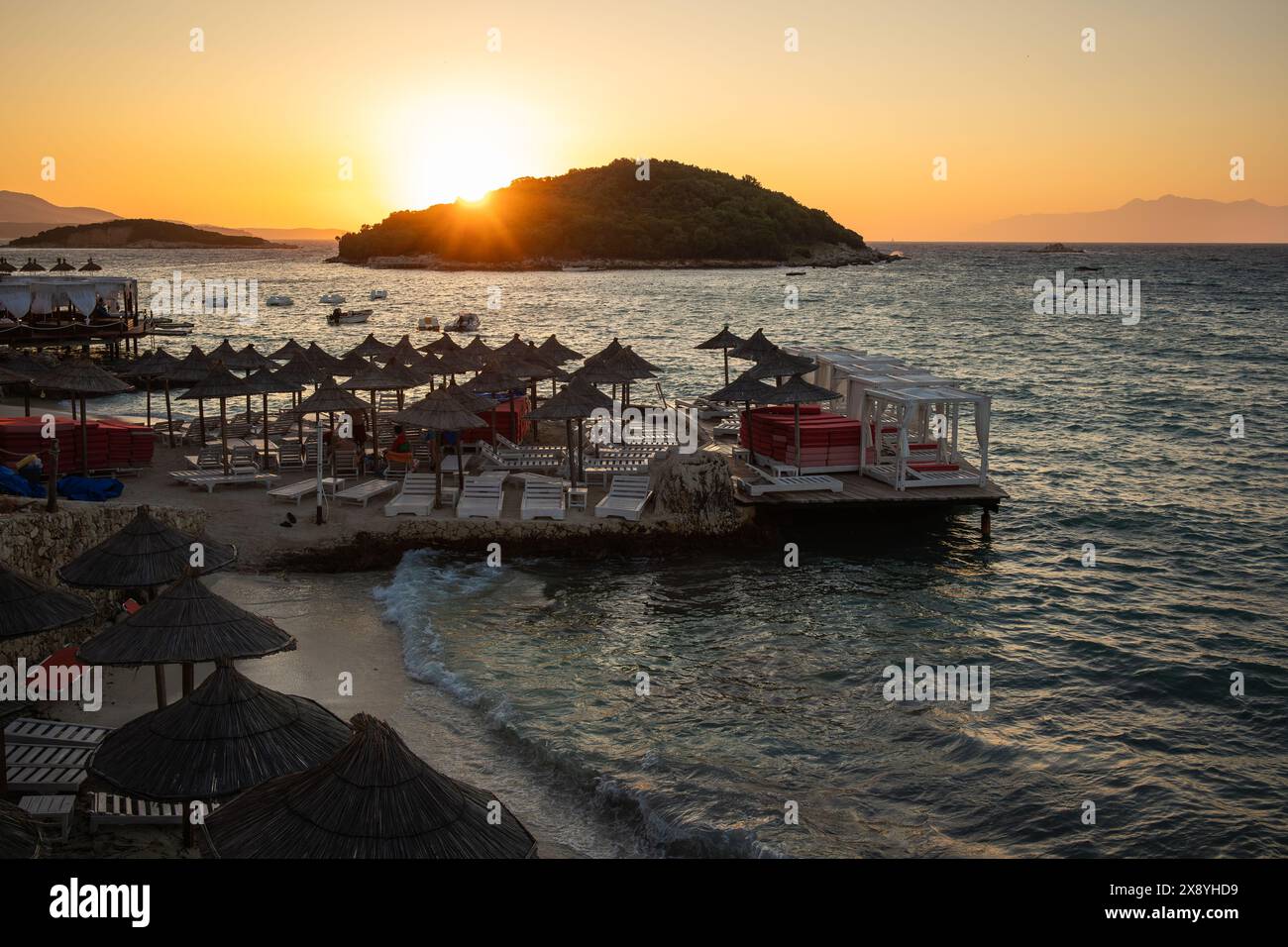 Romantic Scenery of Pier with Sunbeds, Ionian Sea and Ksamil Island ...