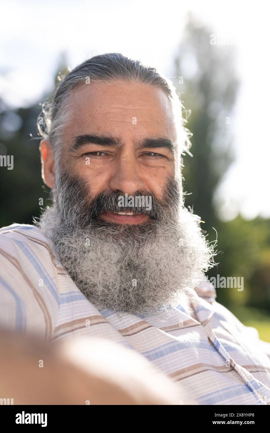 A caucasian senior man wearing striped shirt, smiling outdoors Stock ...