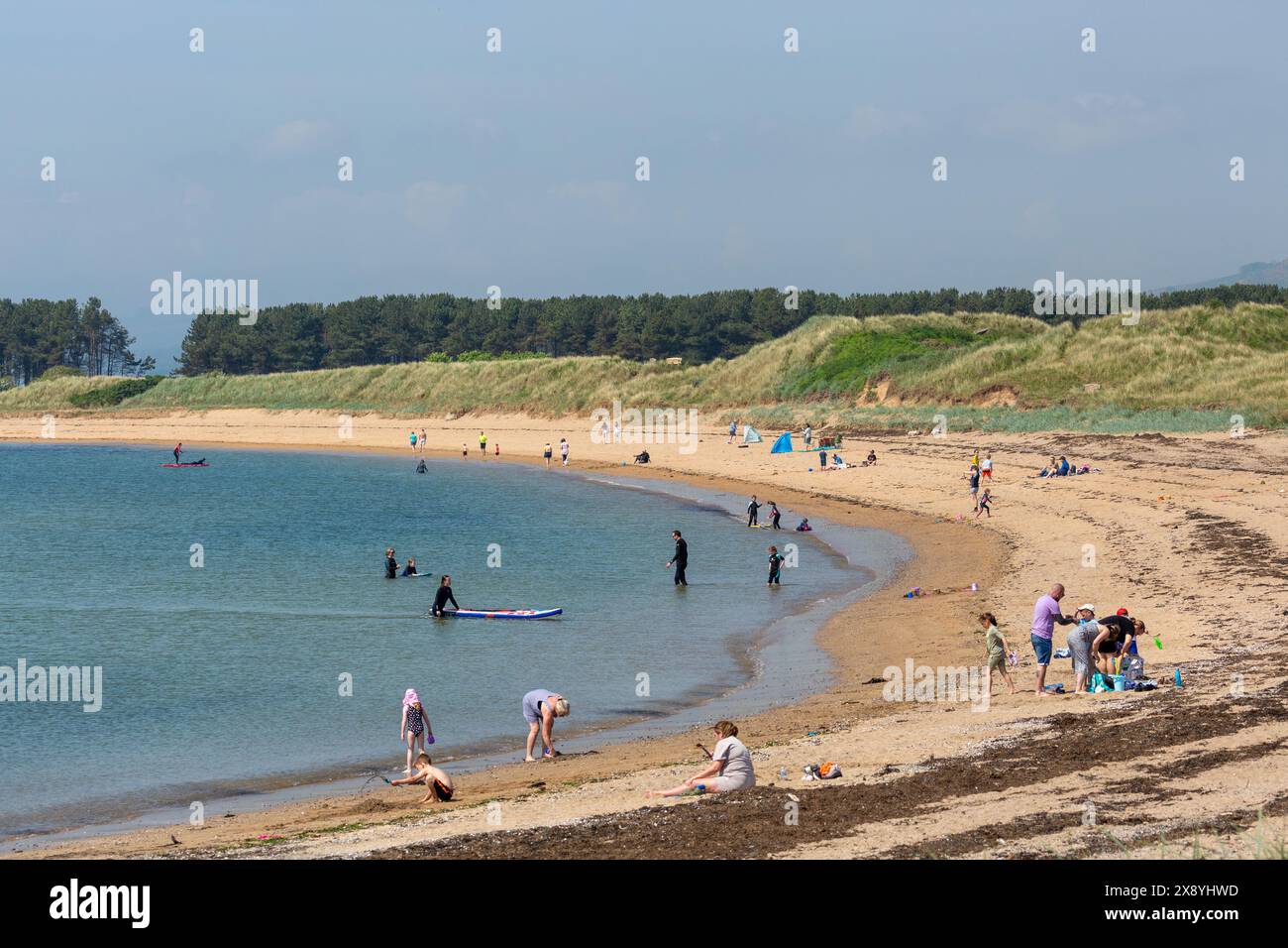 People enjoying sunny weather on the beach at Shell Bay, near Elie ...