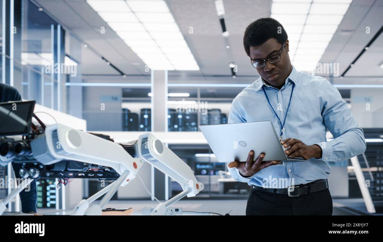 Smart Electronics Engineer Using Laptop Computer, Analyzing Robotic ...