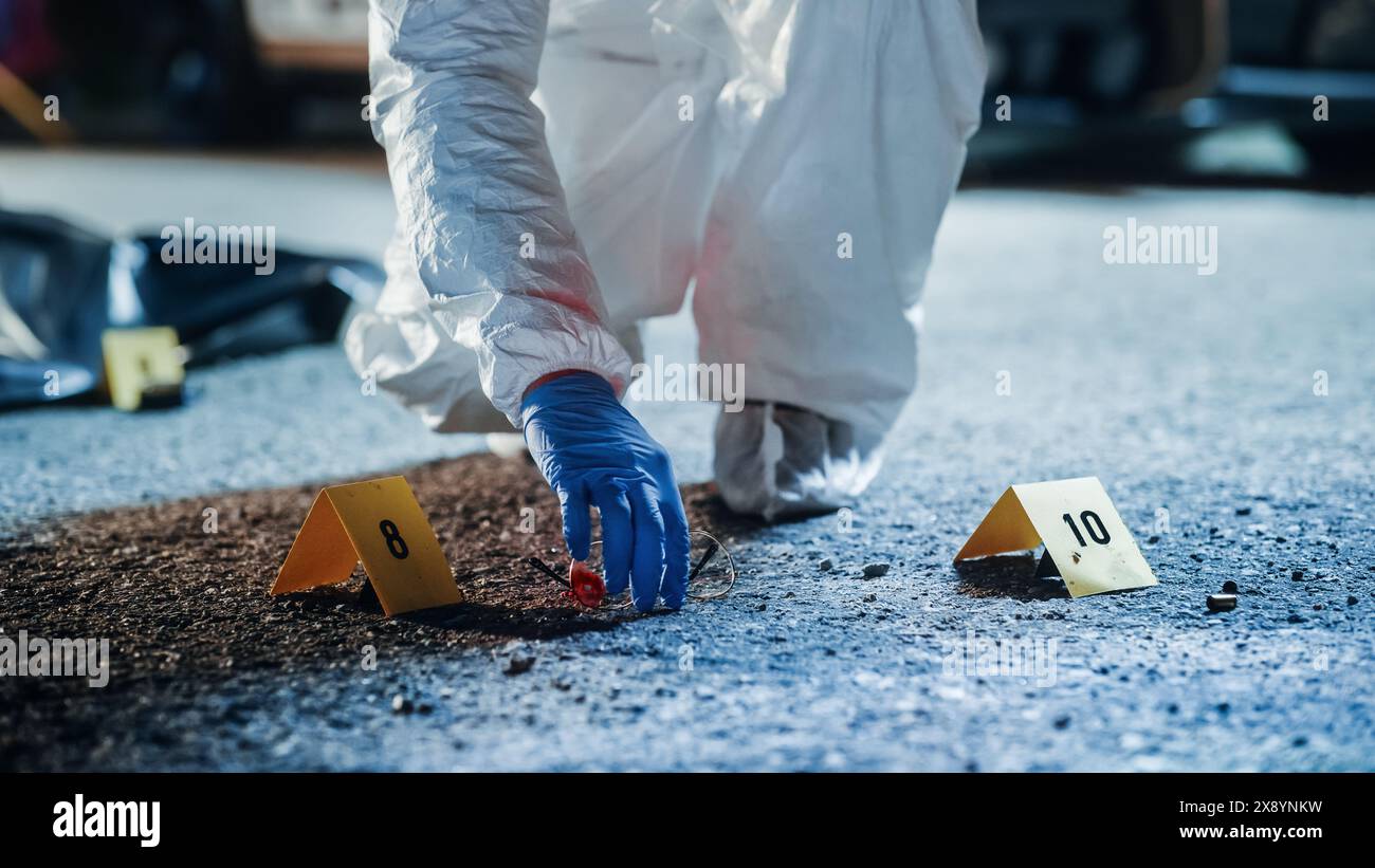 Forensics Team in Action: Expert in Coveralls Retrieving Evidence from ...