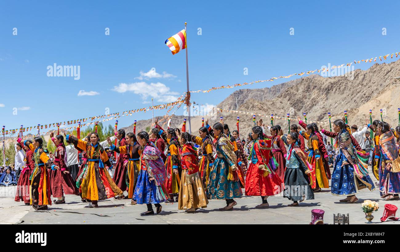 A group of young Buddhist girls performing traditional dance sequence ...