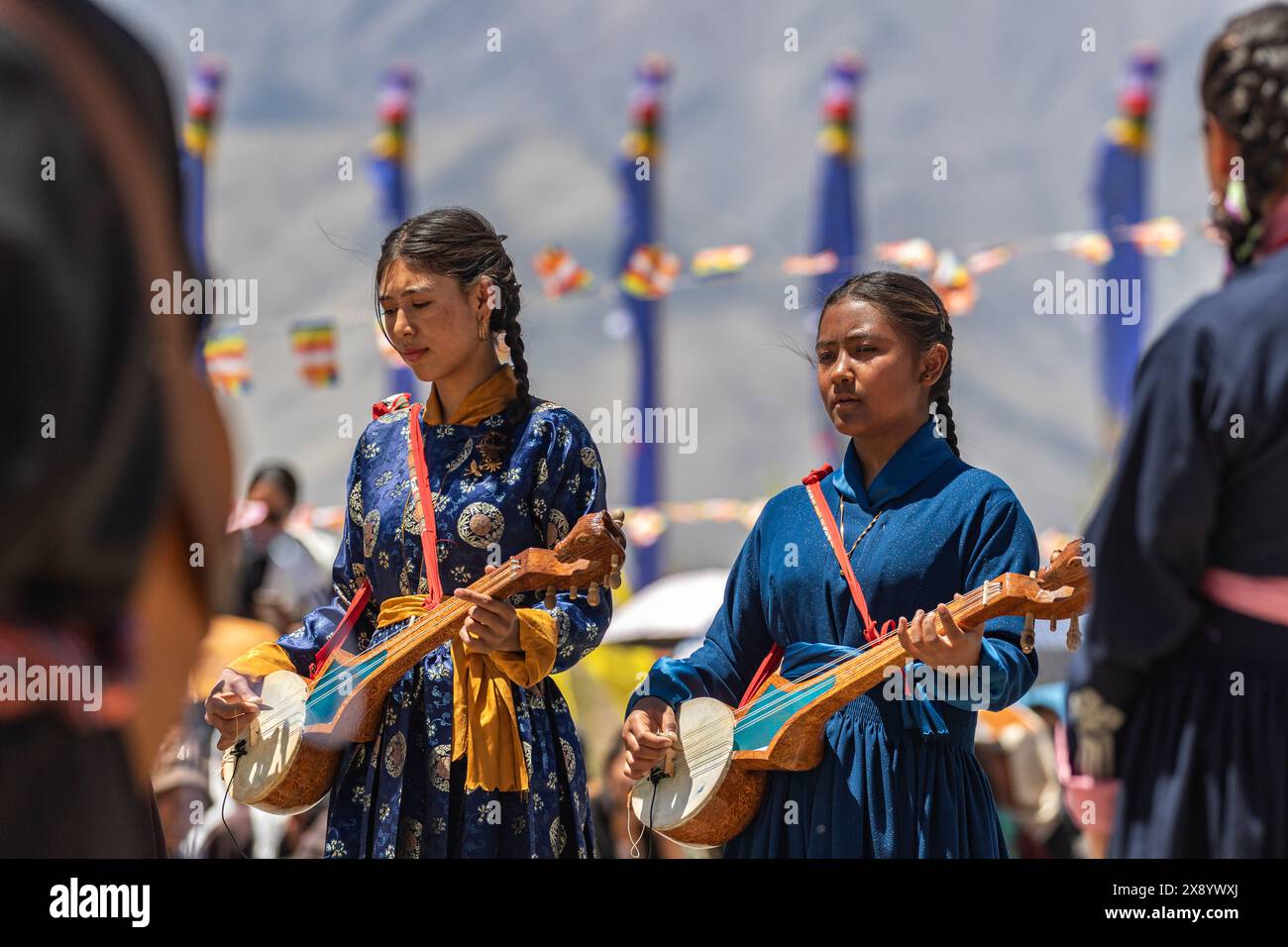 Portrait of young Ladakhi girls wearing traditional attire and playing ...