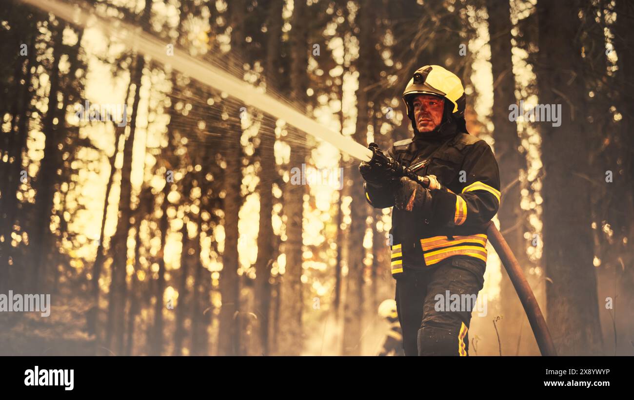 Portrait of a Brave Professional Firefighter Using a Firehose to Fight ...