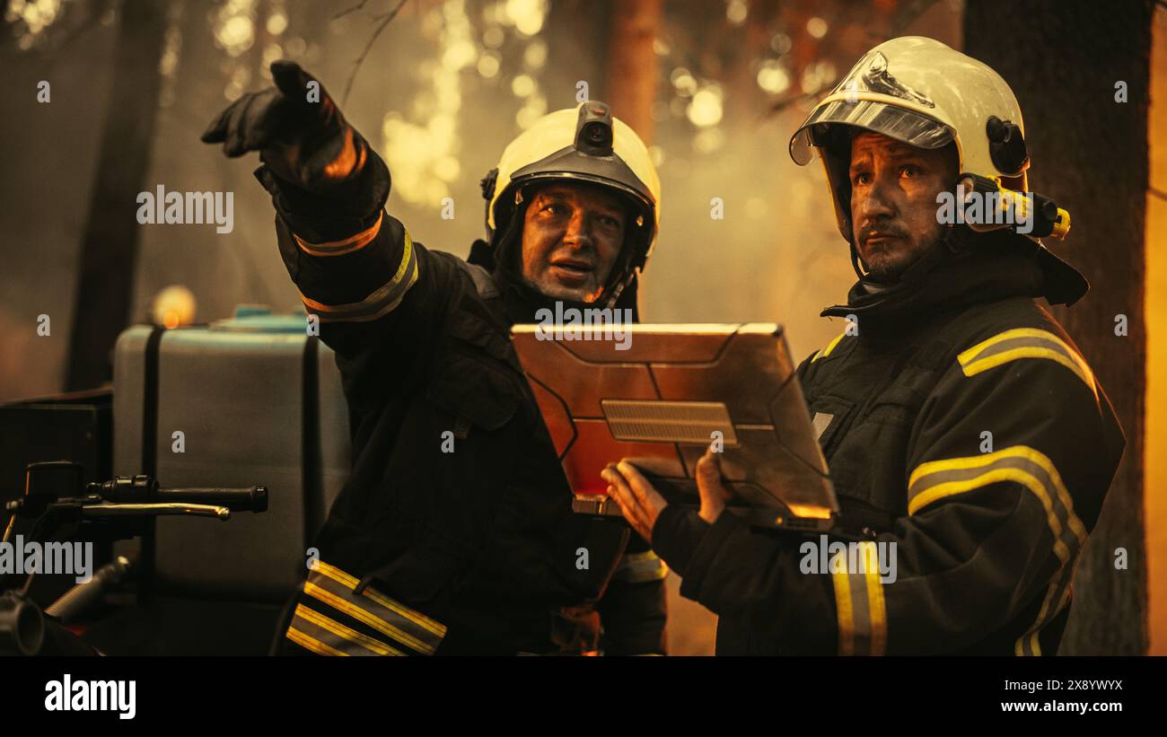 Portrait of Two Professional Firefighters Standing Next to an All ...