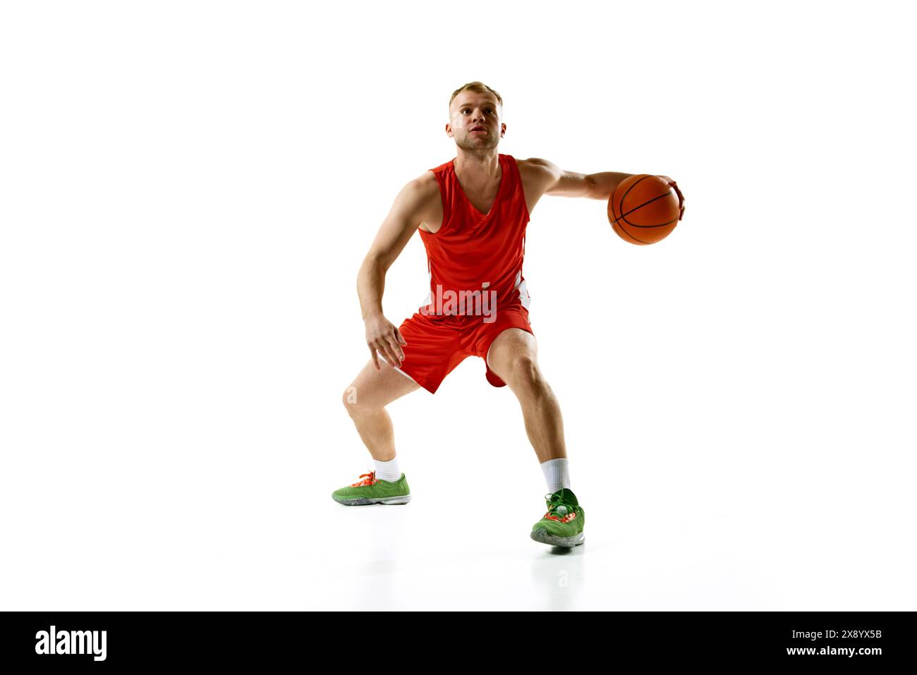 Young athletic man, professional basketball player dressed red uniform ...