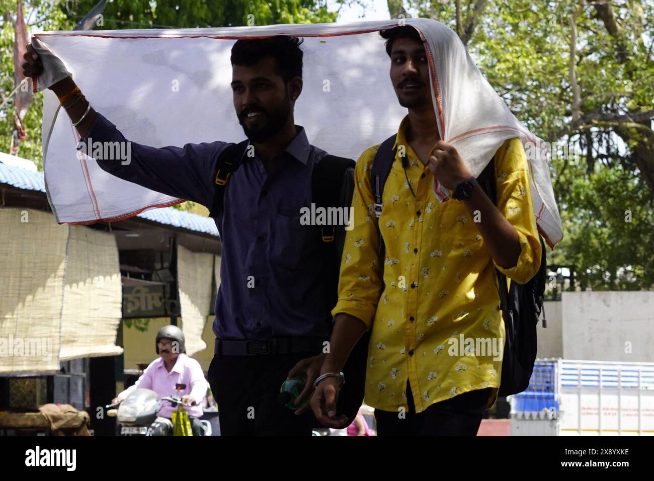 Indian People covers head with a cloth to shelter from the heat on a ...