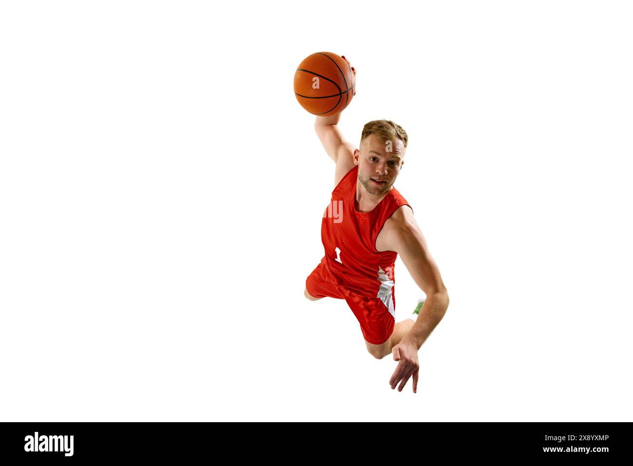 Aerial view of young male basketball player in red gear in mid-jump ...