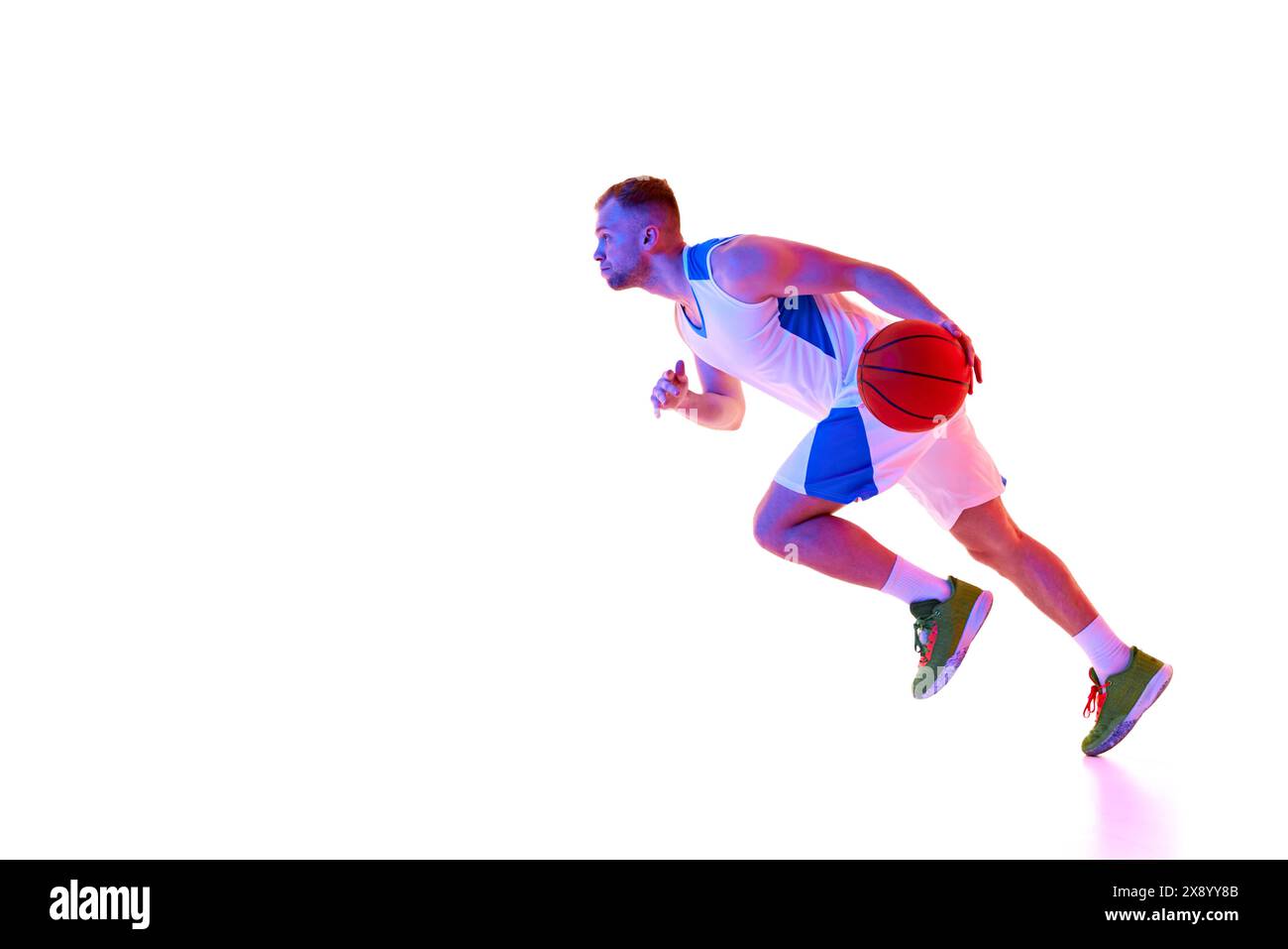 Dynamic shot of young, athletic man running in motion to score perfect goal in neon light ...