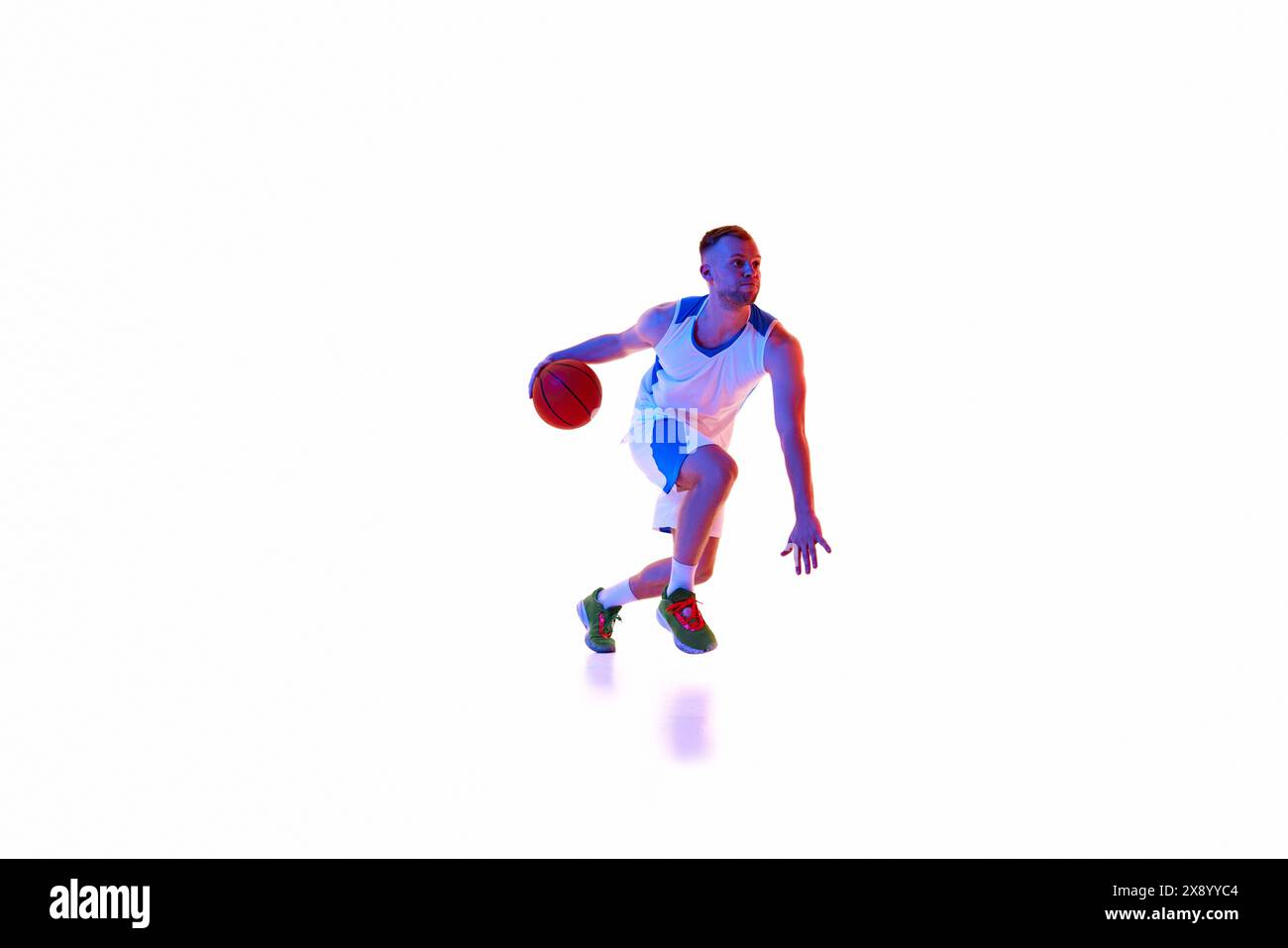 Action shot of young athletic man, basketball player controls ball ...