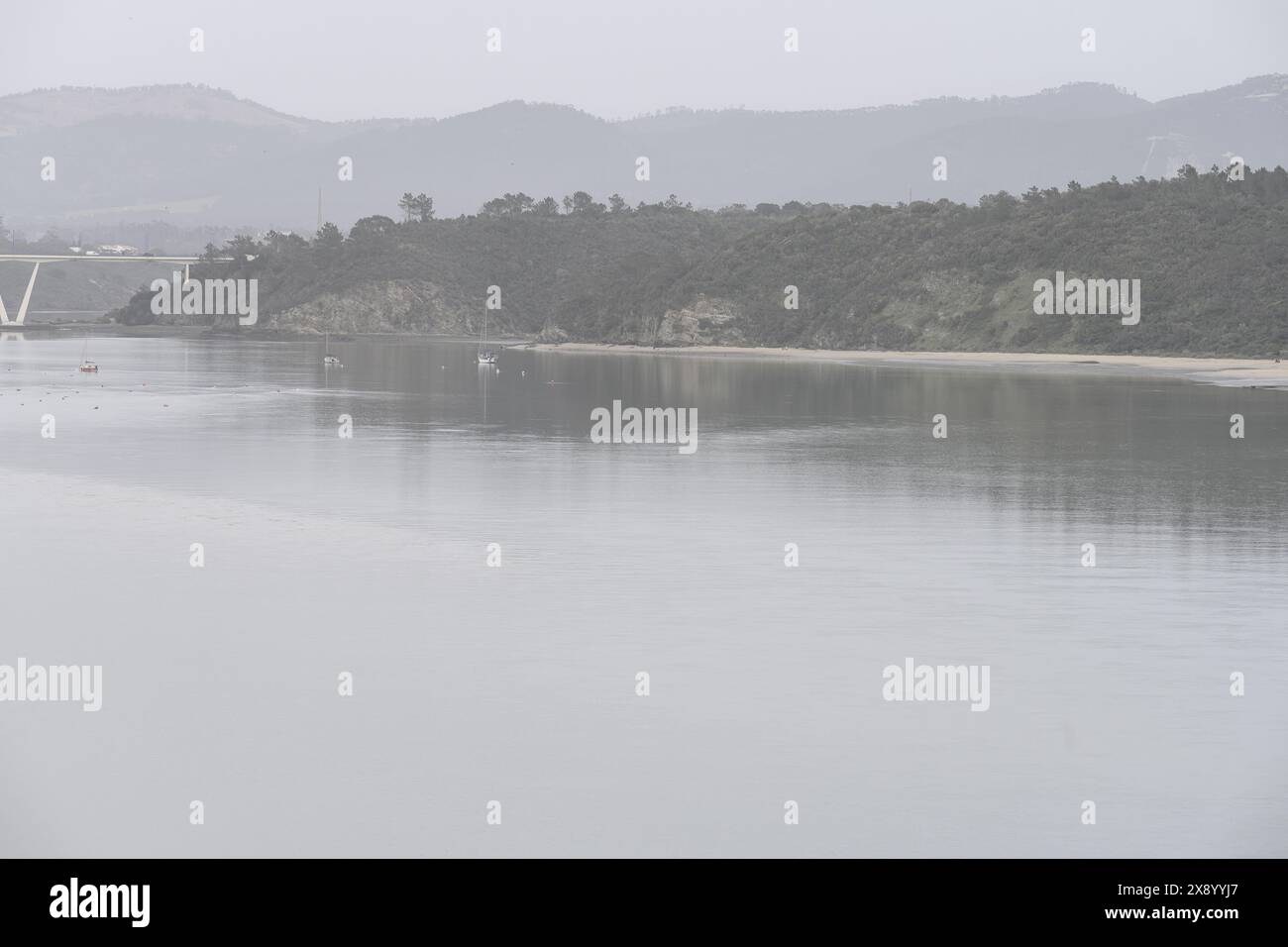 Riverbank landscape featuring bridge mountains hi-res stock photography ...