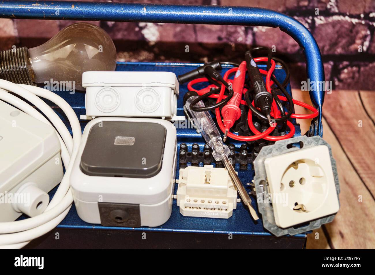 toolbox with switch, socket, light bulb, voltage tester and power cable ...