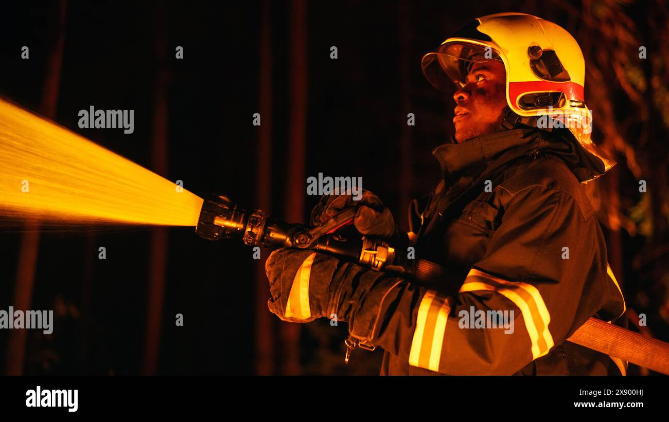 Calm and Focused African American Firefighter Extinguishing a Wildland ...