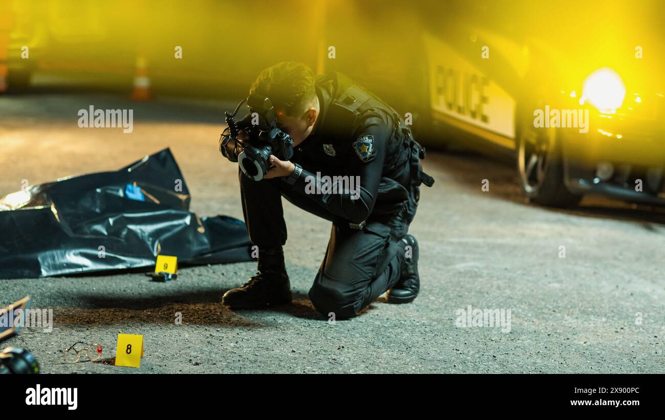 Young Police Officer Taking Forensic Photos of Evidence on a Crime ...