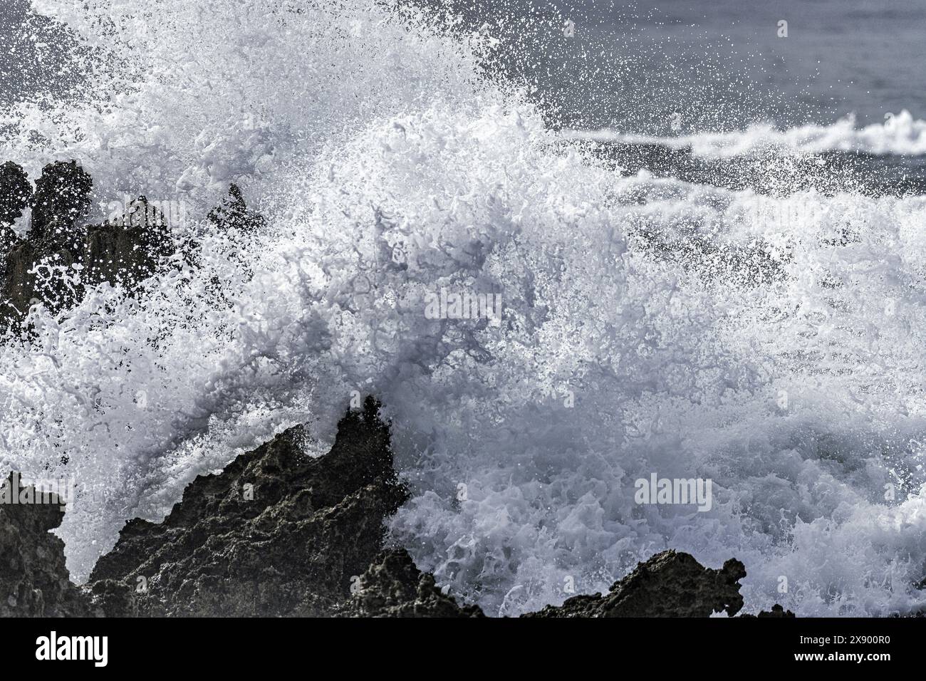 Powerful waves crashing against the rugged rocky shore at Amoreira ...