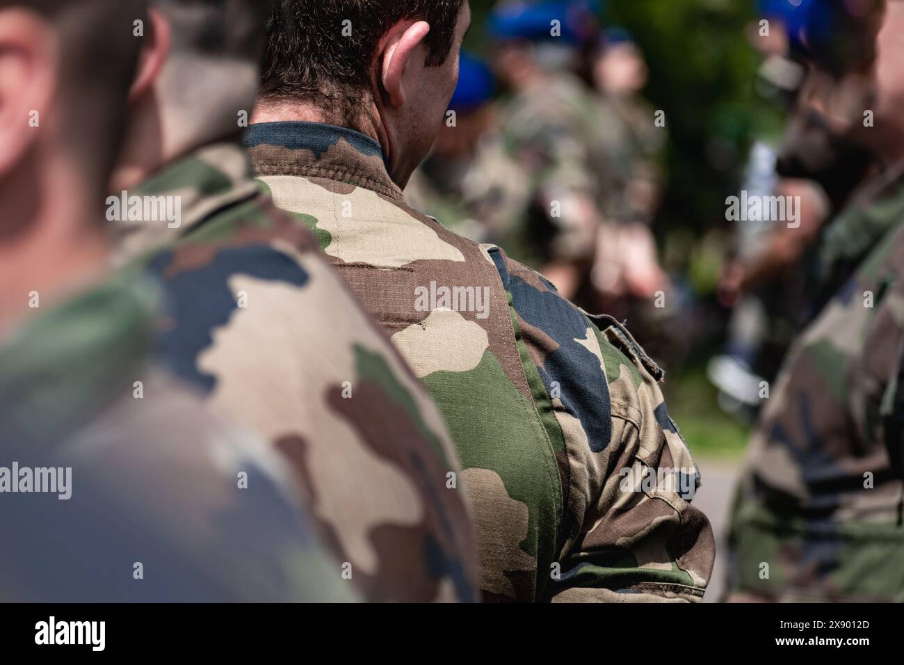 French soldier wearing camouflage uniform, close-up on his back with ...