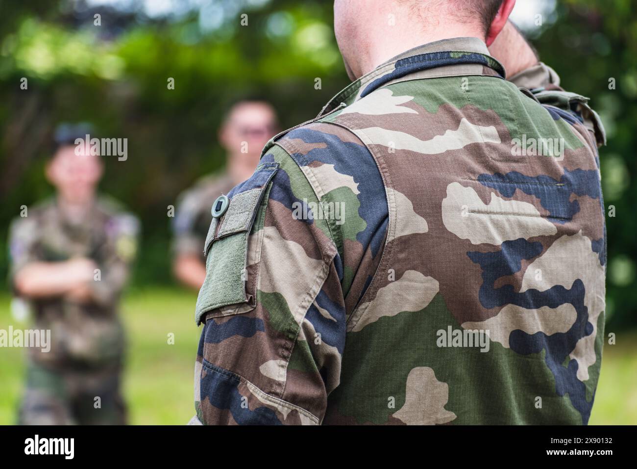 French soldier wearing camouflage uniform, close-up on his back with ...