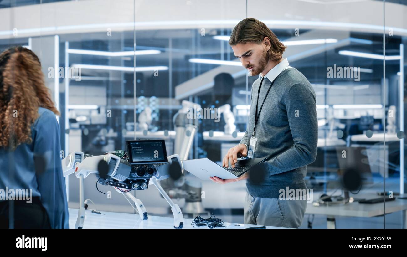 Young System Administrator Checking Online Internet Connectivity with a Prototype AI Robot ...