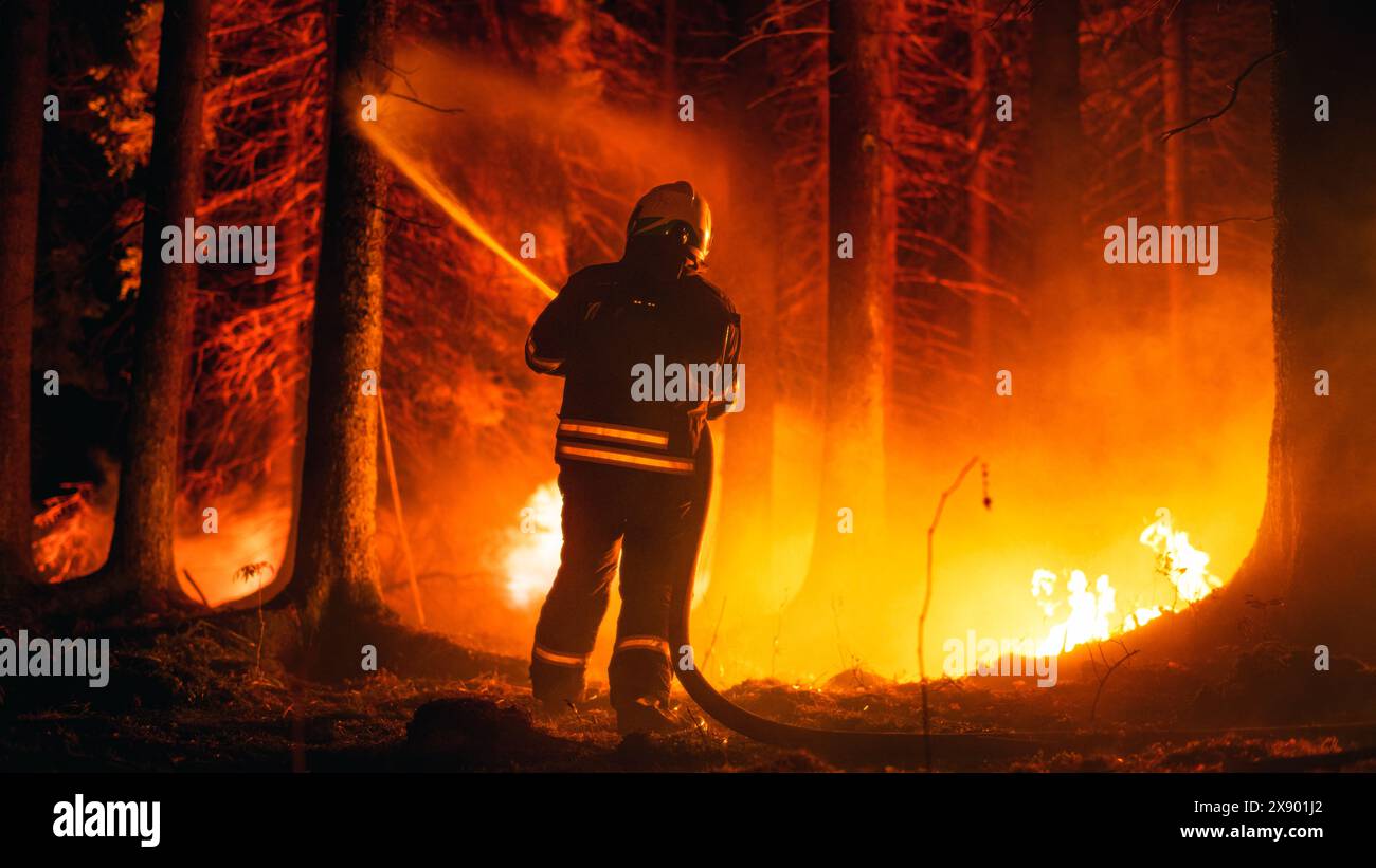 Elite Firefighter Methodically Extinguishing a Large Forest Fire with ...