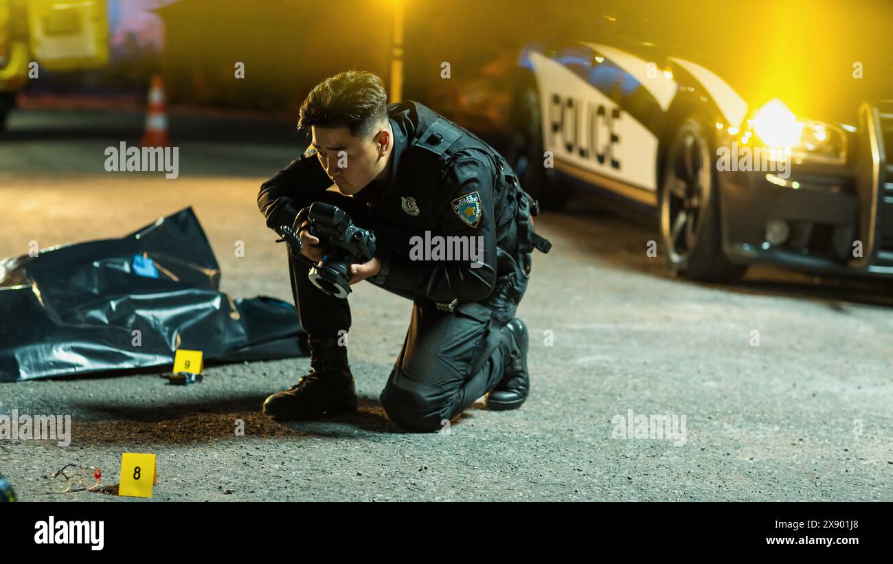 Young Asian Policeman with Camera is Doing Forensic Work on a Crime ...