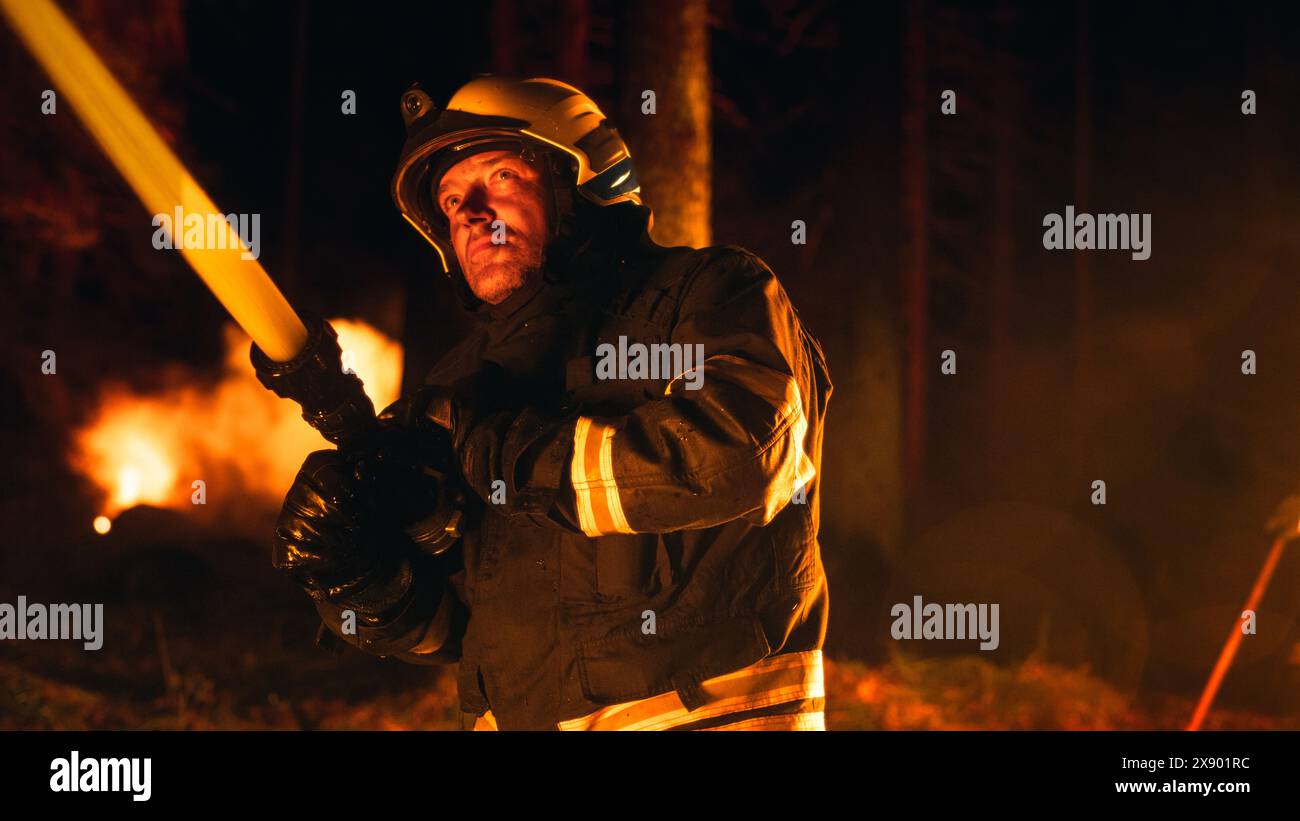 Portrait of a Brave Professional Firefighter Using a Firehose to Fight ...
