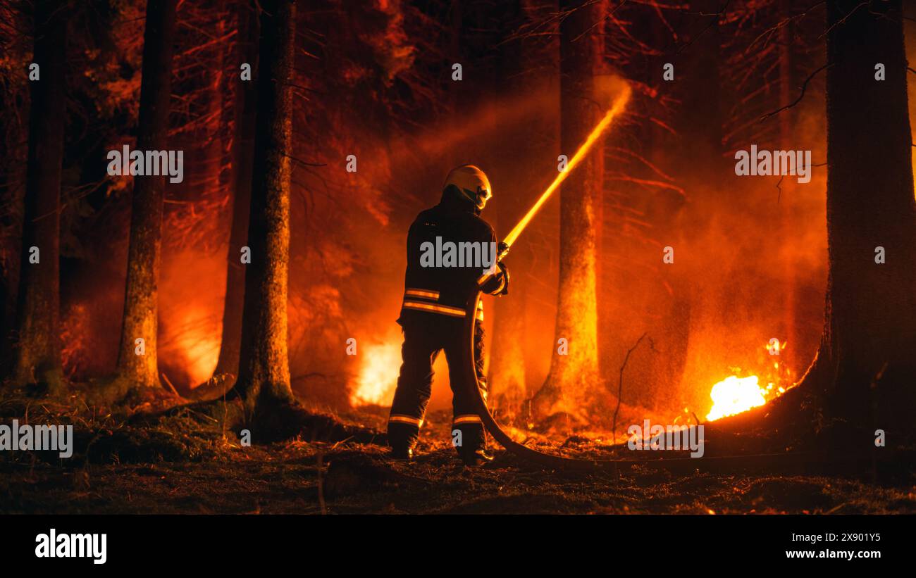 Professional Firefighter Quickly Extinguishing a Forest Fire with the ...