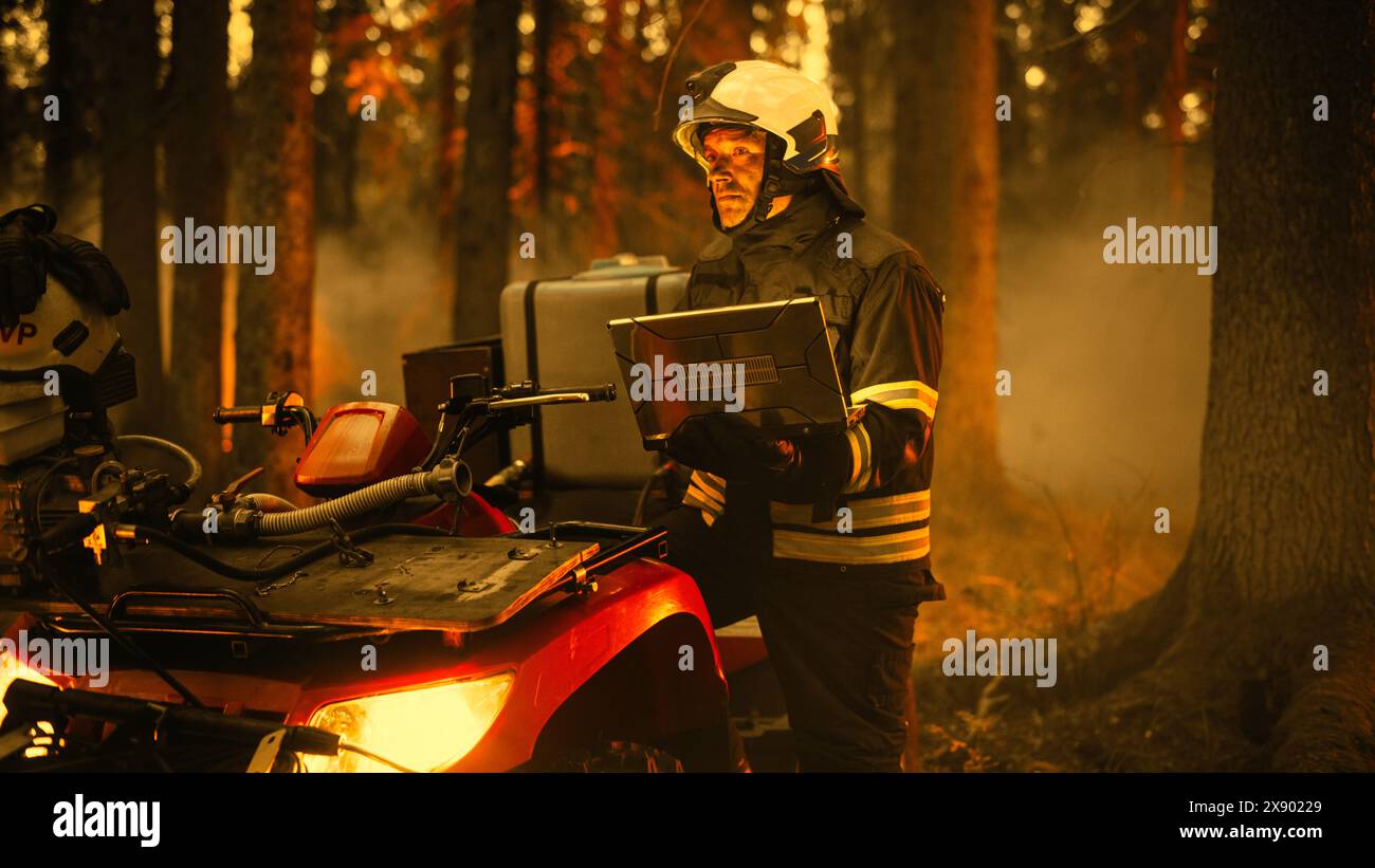Brave Skillful Firefighter Standing Next to an ATV, Using Laptop ...
