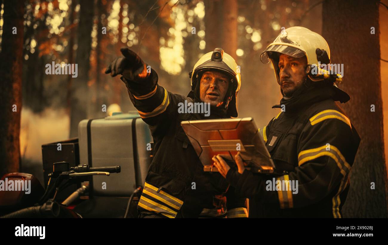 Portrait of Two Professional Firefighters Standing Next to an All ...