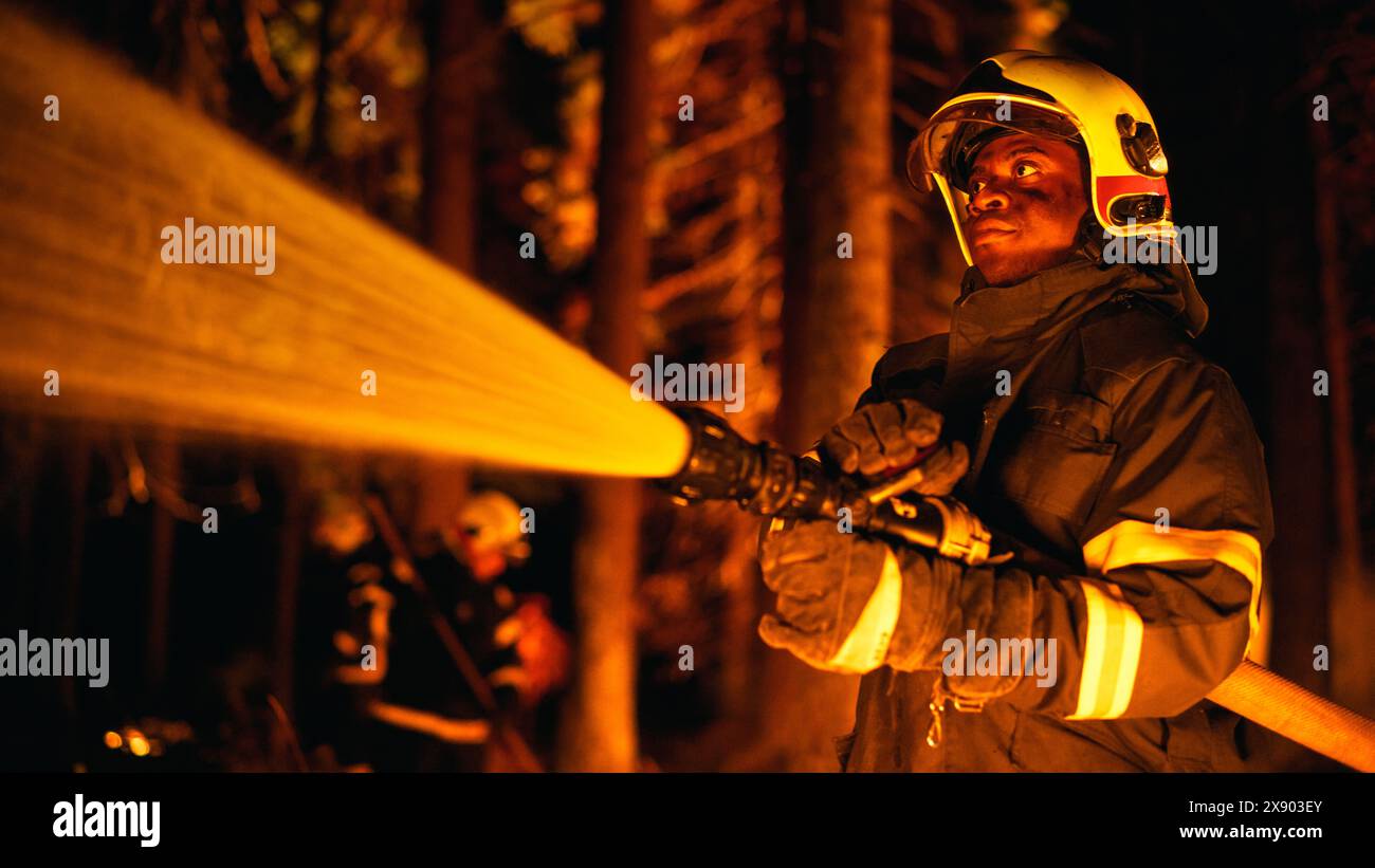 Experienced Back Firefighter Extinguishing a Wildland Fire Deep in a ...