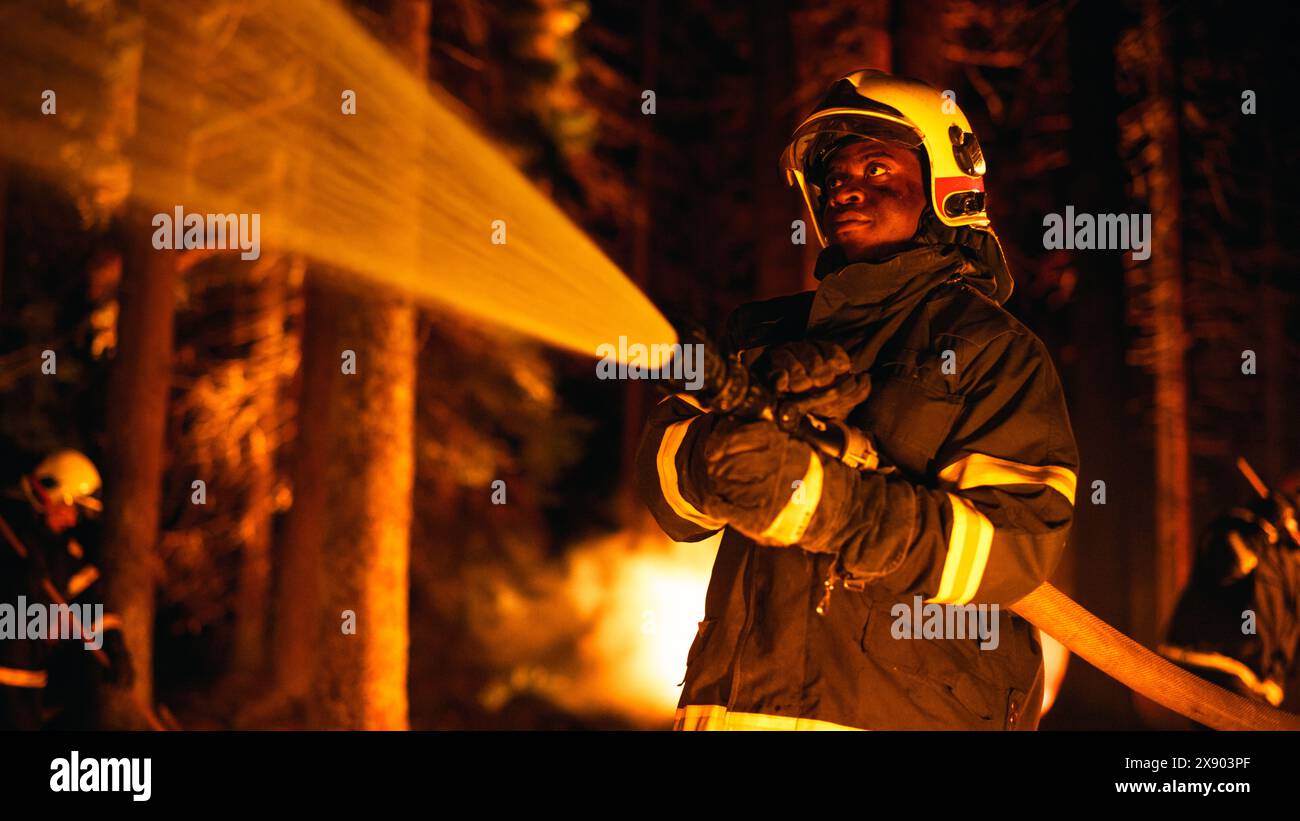 Calm and Collected African American Firefighter Extinguishing a ...