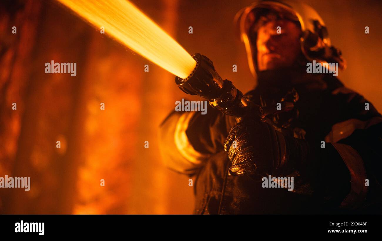 Close Up Low Angle Portrait of a Brave Professional Firefighter Using a ...