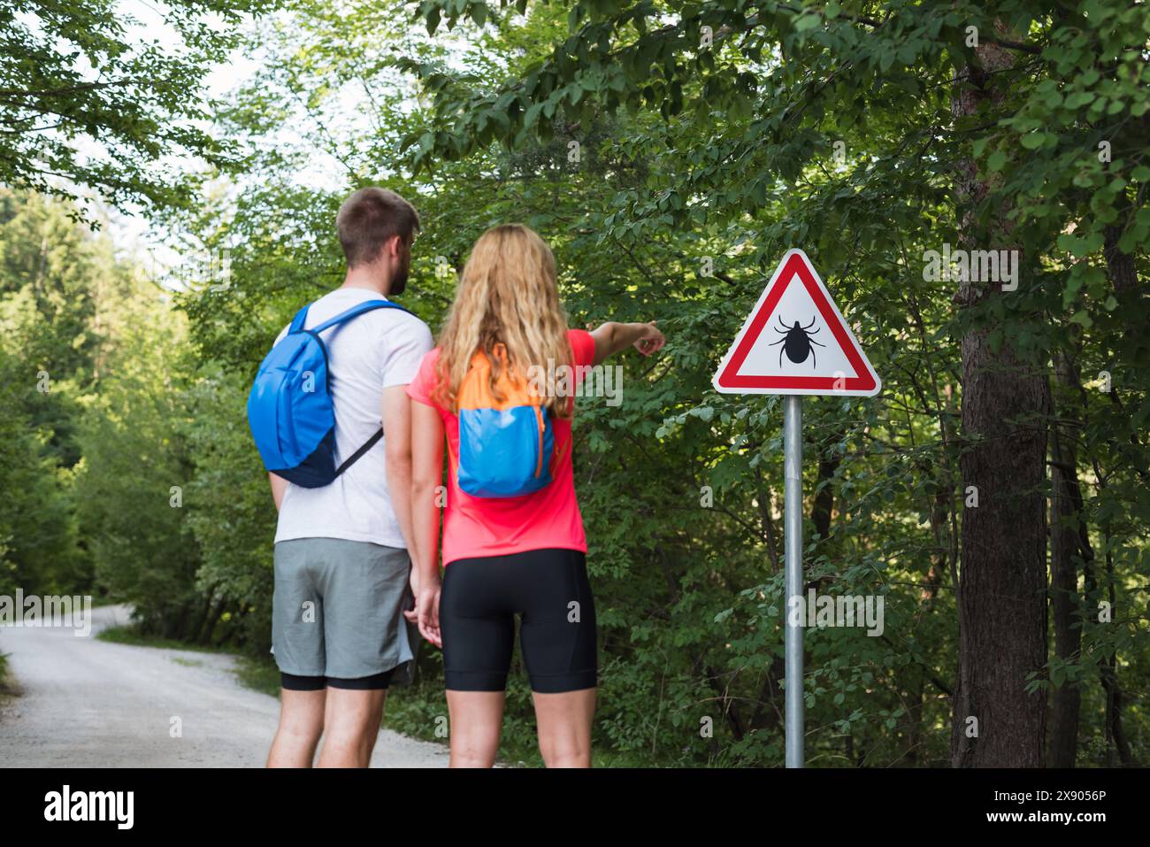 Man and woman pointing fingers in the distance while hiking near the ...