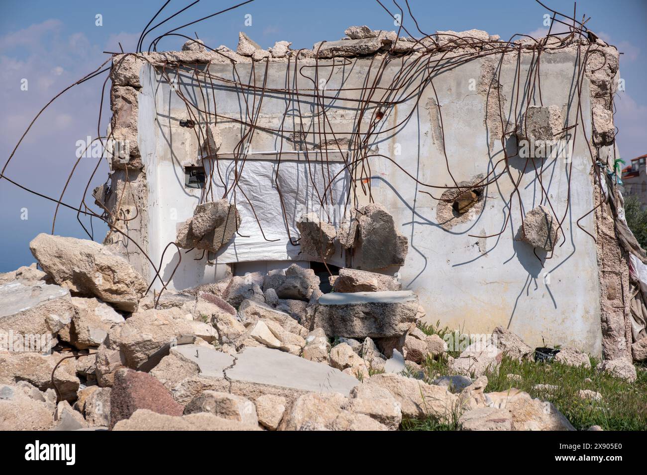 Ruined building. A pile of concrete, rubble and reinforcement debris in ...