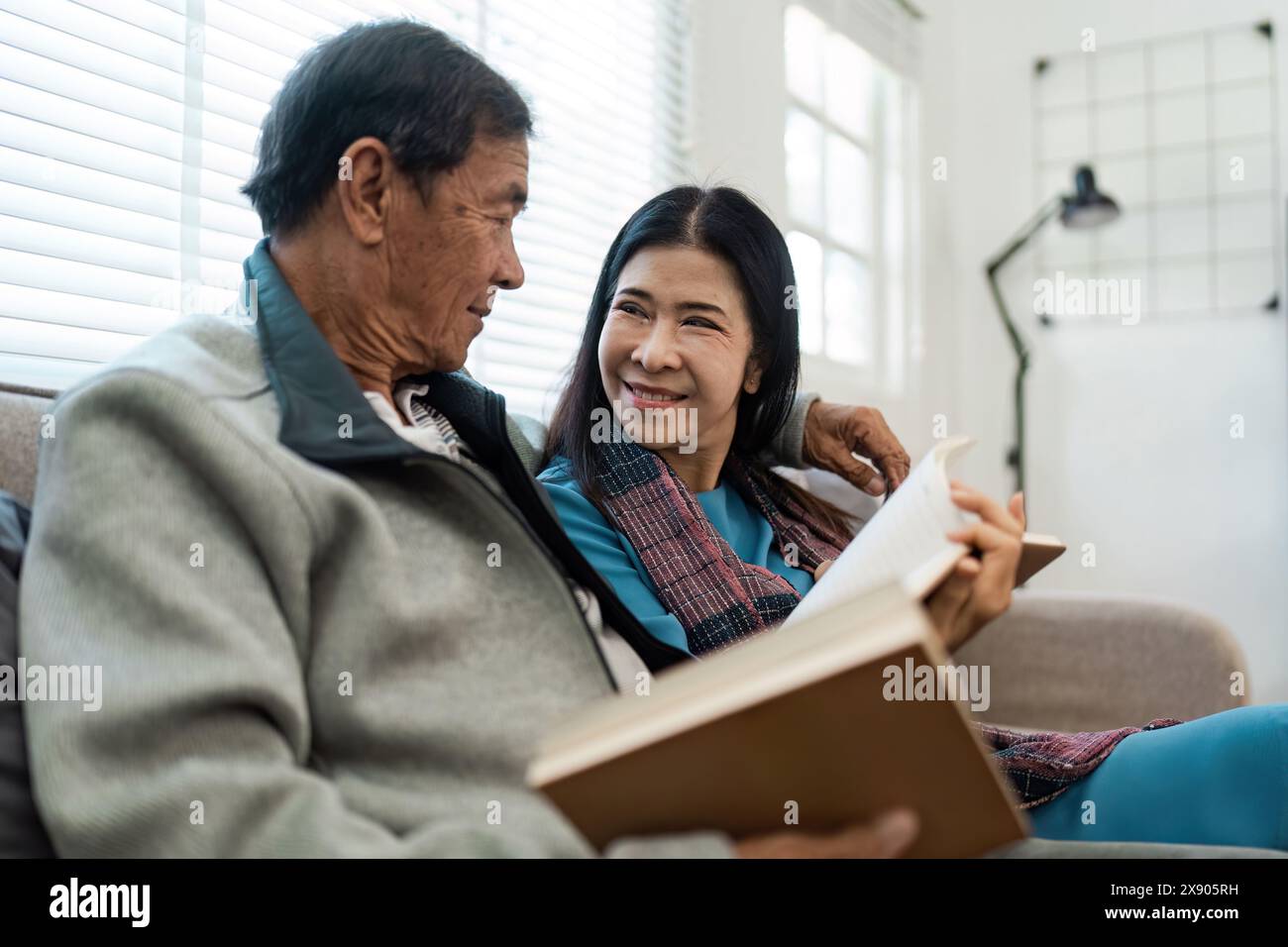 senior married couple enjoying quality time reading books together on ...