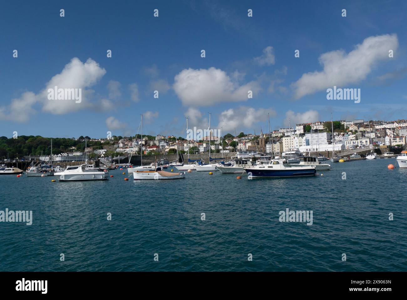 View to water craft moored in St Peter Port harbour from a departing ...